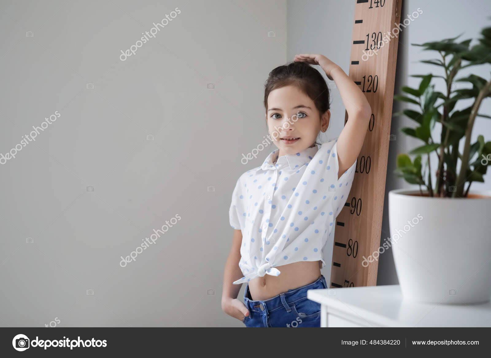 Little Girl Measuring Height Home Stock Photo by ©serezniy 484384220