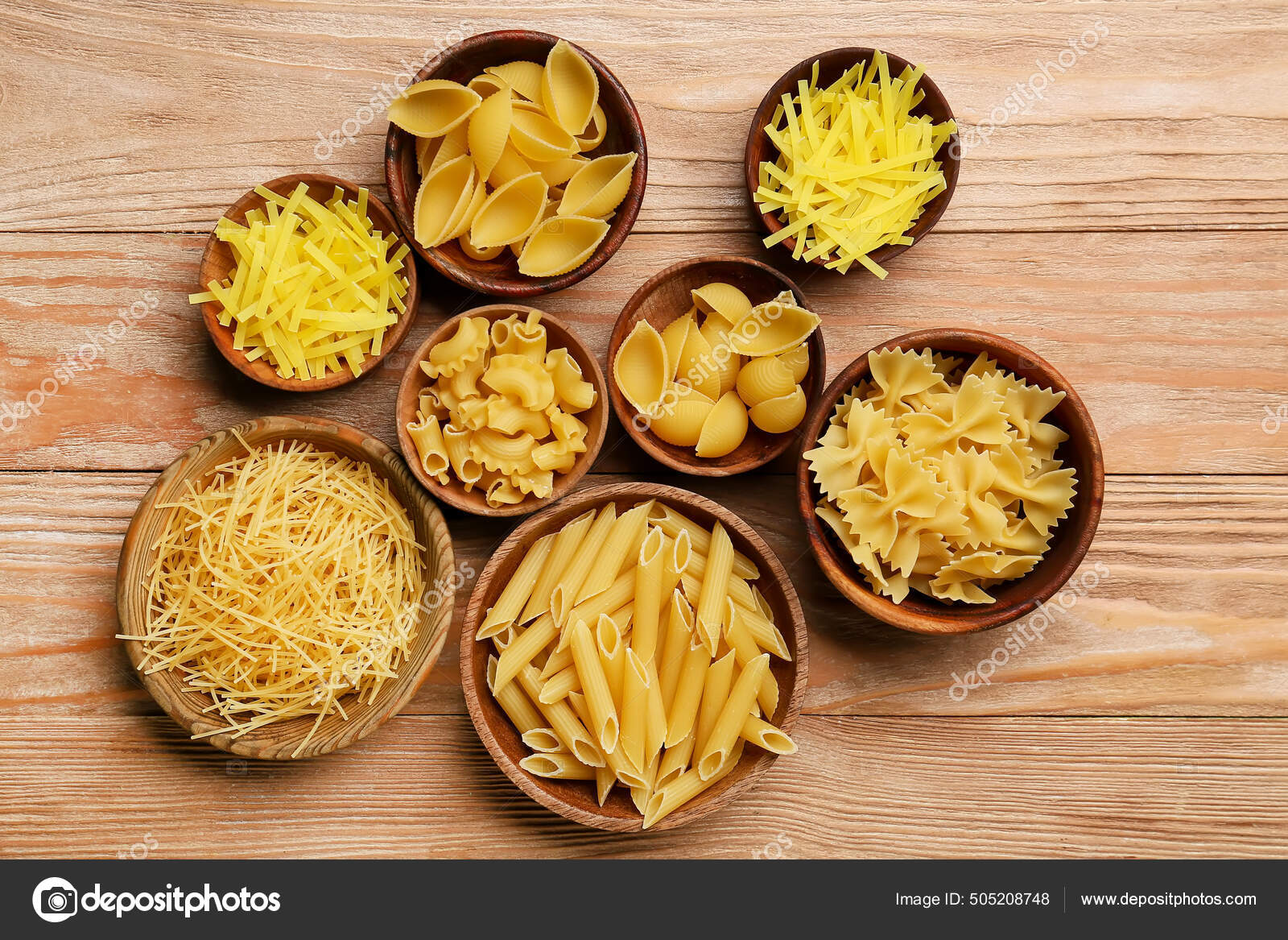 Bowls Different Types Uncooked Pasta Wooden Background Stock Photo by ...