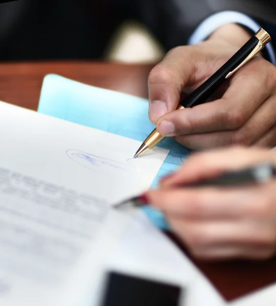 Two business partners signing a document - Stock Image - Everypixel