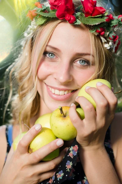 Pretty young apple fairy with three fruits - Stock Image - Everypixel