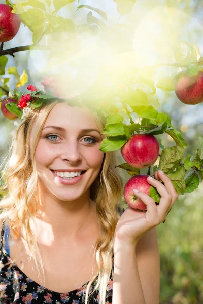 pretty young apple fairy with three fruits - Stock Image - Everypixel