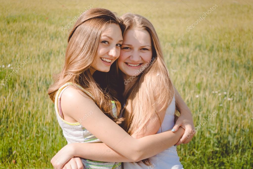 Two happy female friends hugging in green summer park — Stock Photo ...