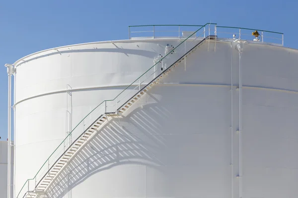 White tanks in tank farm with iron staircase - Stock Image - Everypixel