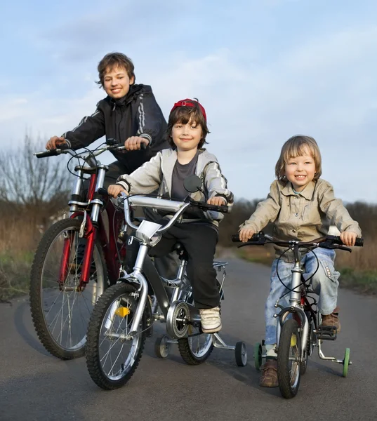three brothers ride bikes - Stock Image - Everypixel
