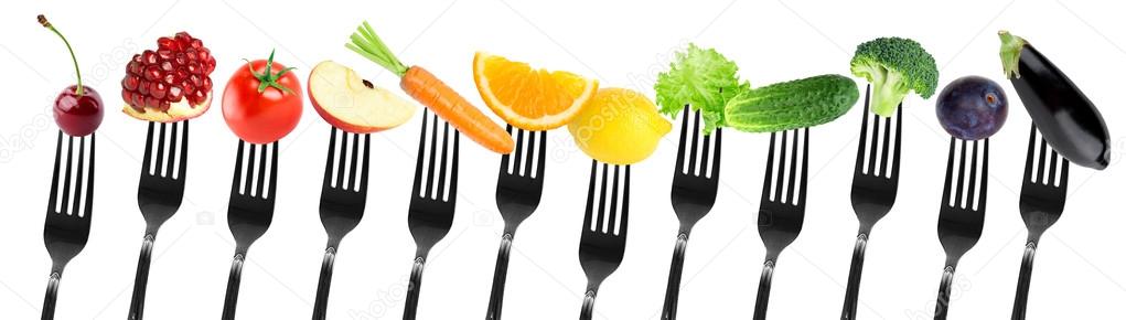 Fruits and vegetables on fork Stock Photo by ©seralex 83577744