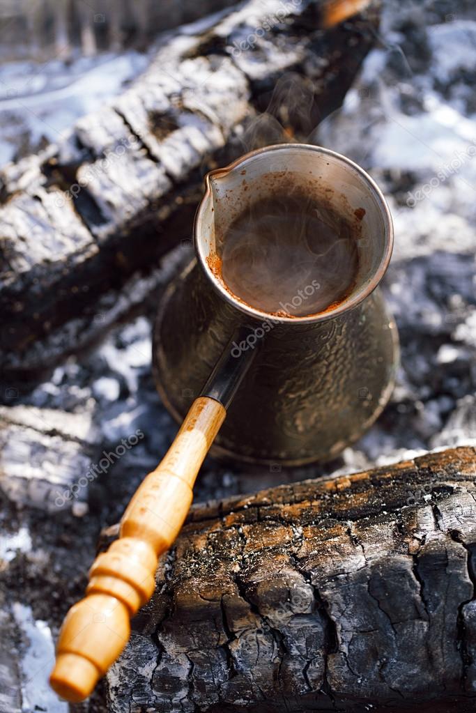 Making coffee in the fireplace — Stock Photo © lvenks #53412937