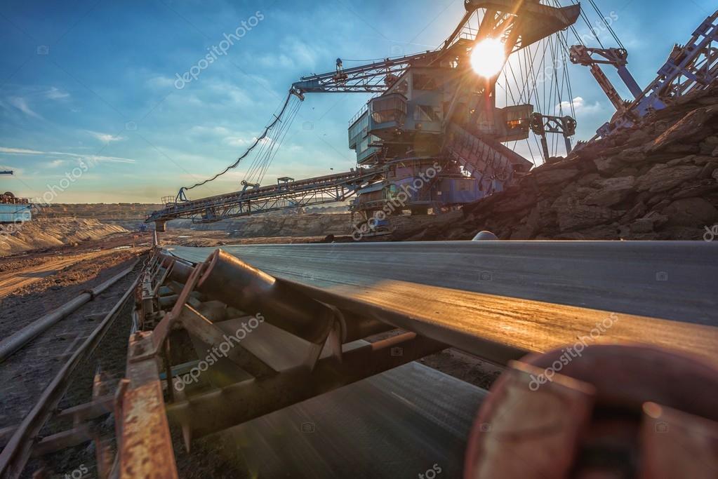 Long conveyor belt transporting ore Stock Photo by ©svedoliver 110559806