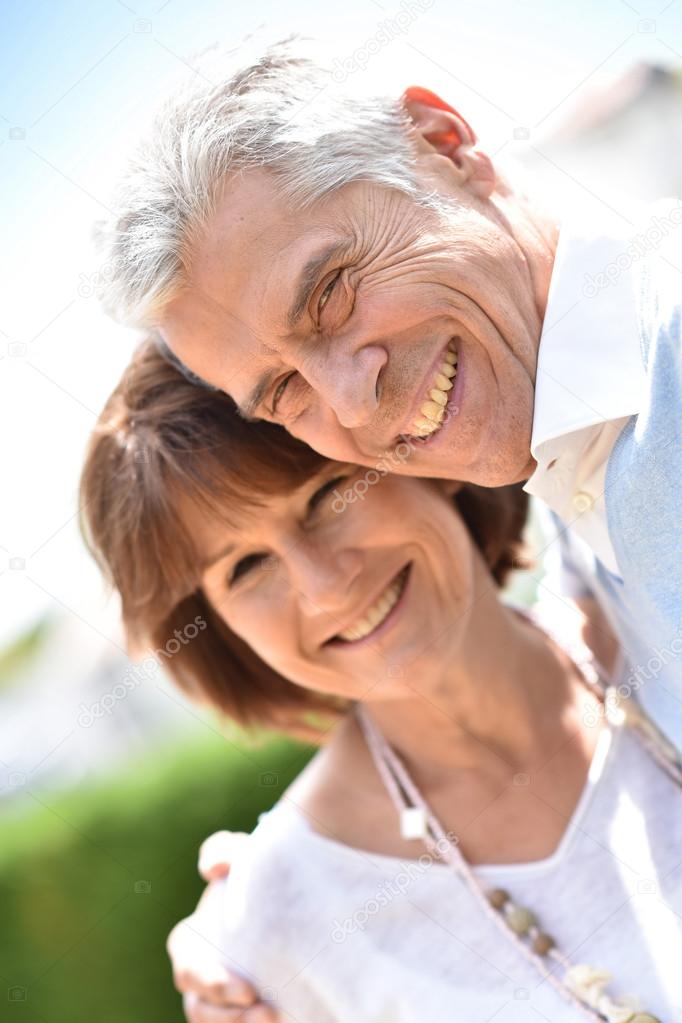 Mature couple embracing each other Stock Photo by ©Goodluz 120466460