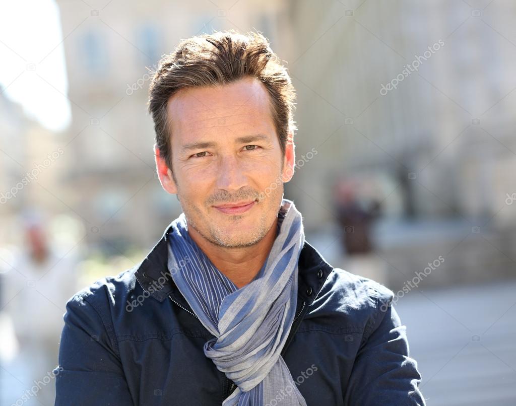 Smiling 40-year-old man in town — Stock Photo © Goodluz #53288951