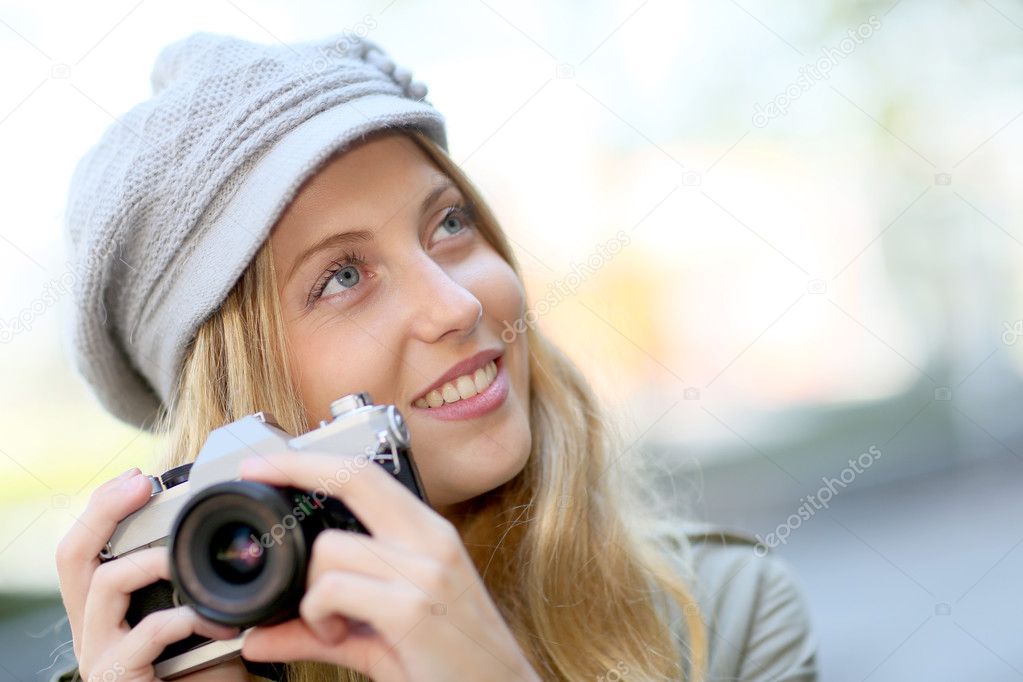 Young woman with camera — Stock Photo © Goodluz #58085881