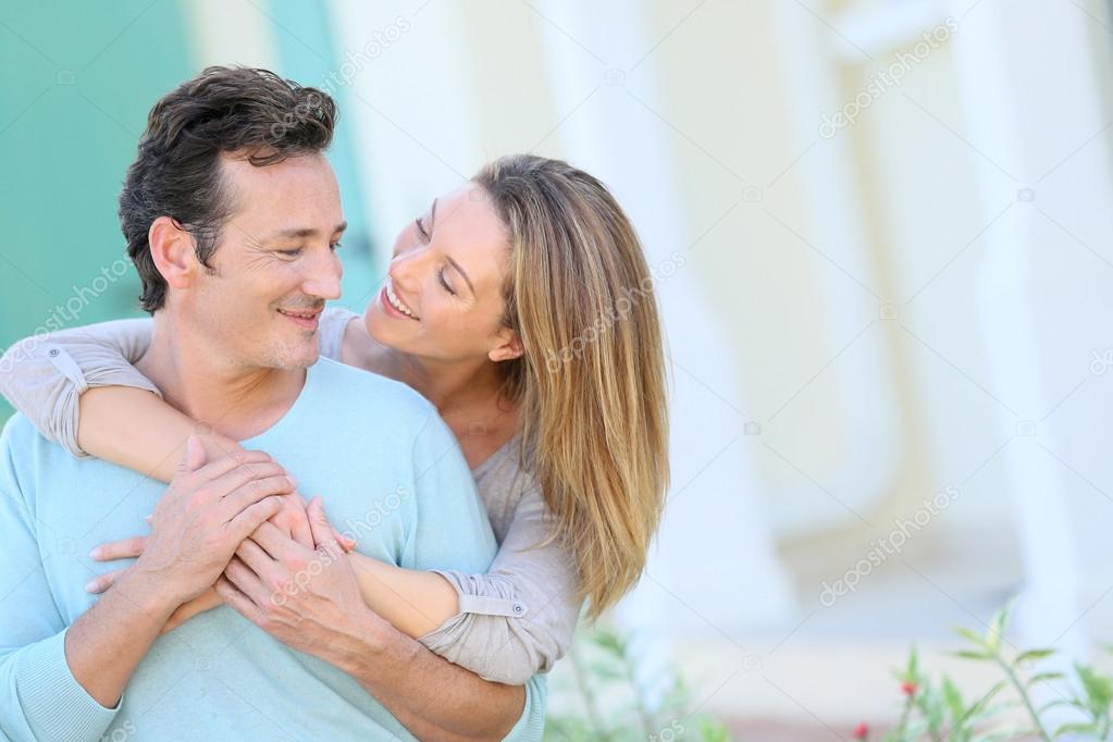 Middle-aged couple embracing — Stock Photo © Goodluz #64685415