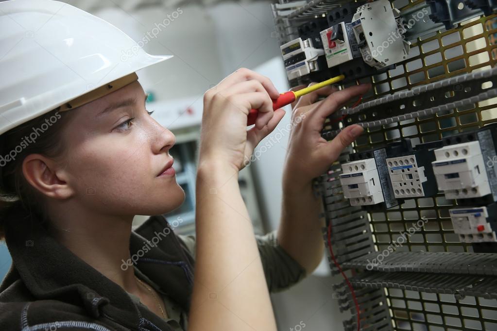Woman setting up electrical circuit — Stock Photo © Goodluz #79360120