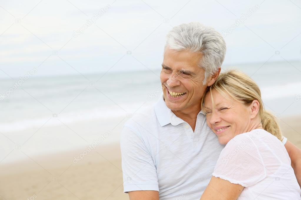 Couple embracing on the beach — Stock Photo © Goodluz #85188248