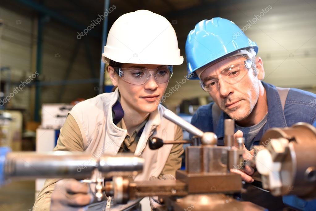 Metal worker teaching trainee — Stock Photo © Goodluz #99105390