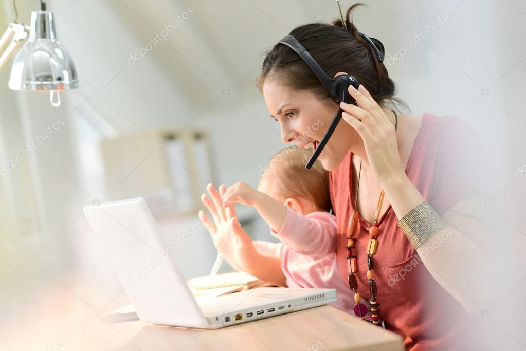 Mother getting busy working — Stock Photo © Goodluz #99747304
