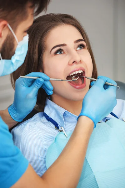 Young woman getting her teeth checked by a dentist. ⬇ Stock Photo ...