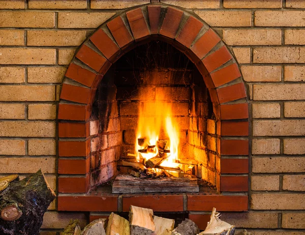 open fire in indoor brick fireplace - Stock Image - Everypixel