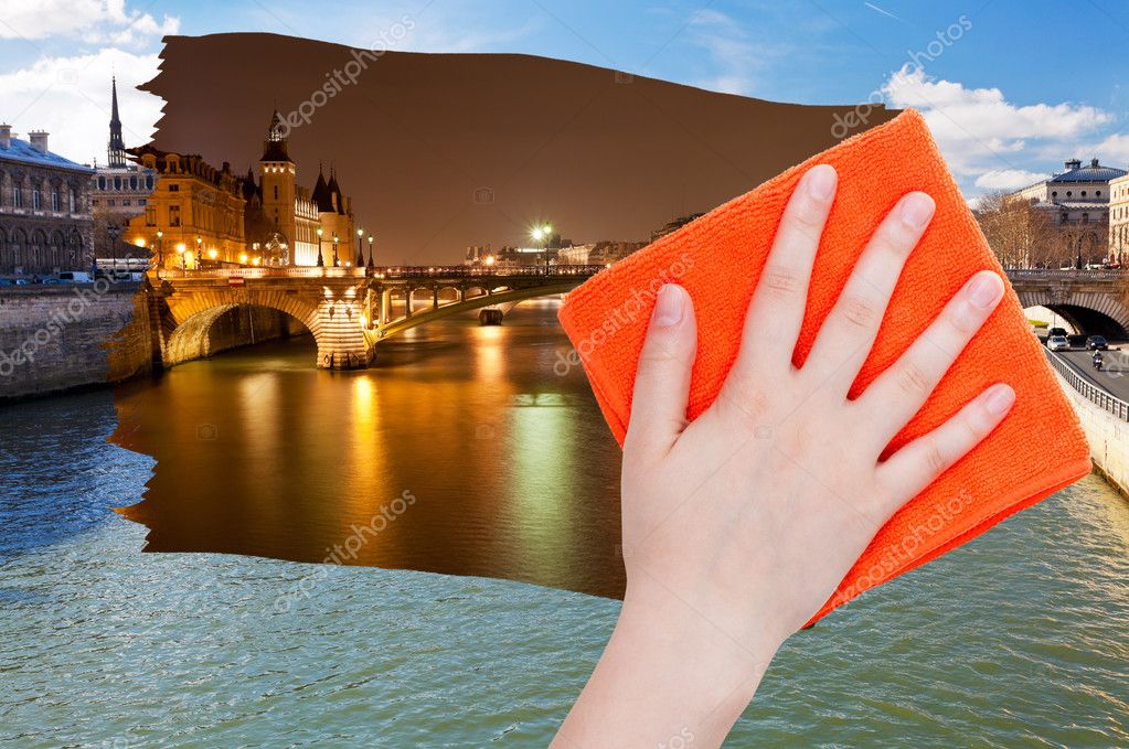 Hand deletes day view of Paris by orange cloth — Stock Photo © vvoennyy ...