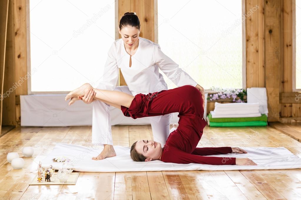 Woman getting thai stretching massage — Stock Photo © kotin #92640850