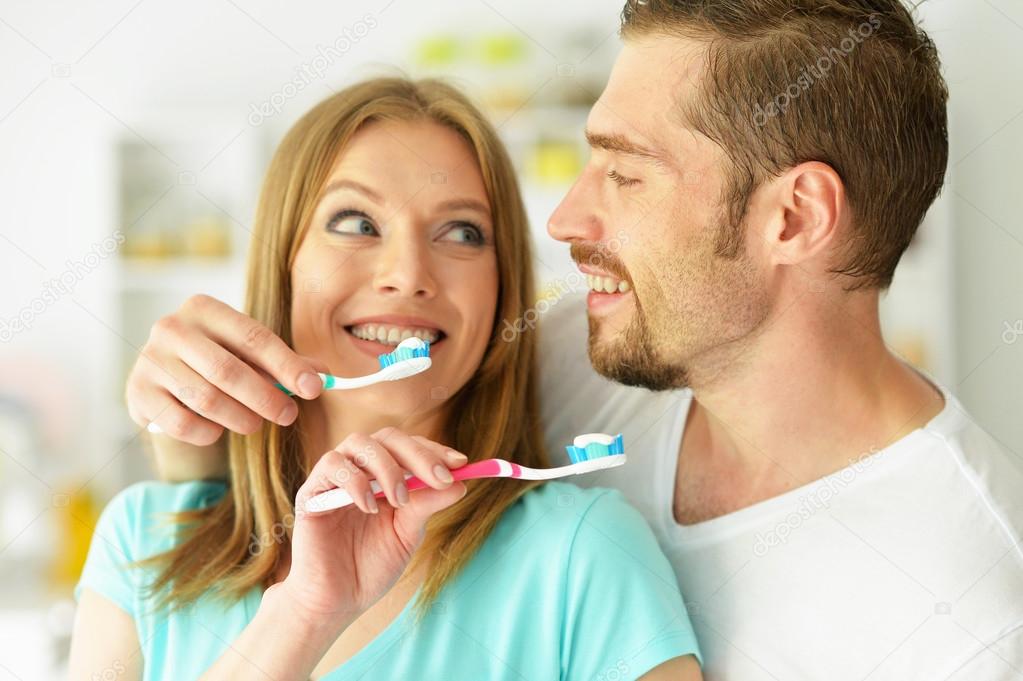 Young couple brushing their teeth Stock Photo by ©aletia 112547932