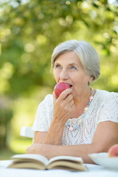 Middle-aged woman reading a book - Stock Image - Everypixel