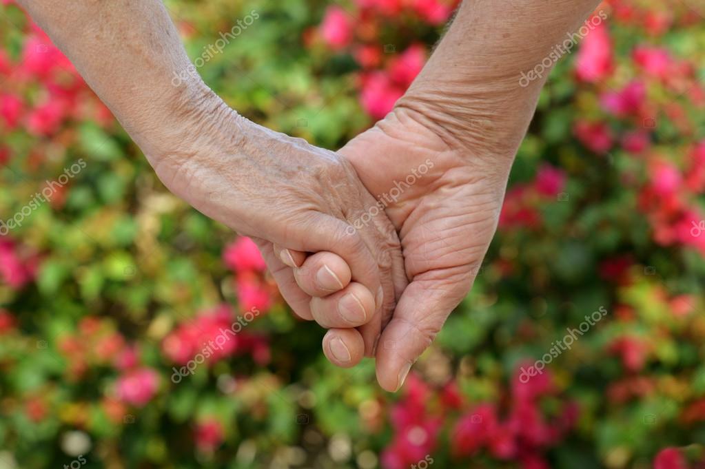Elderly couple holding hands — Stock Photo © aletia #65080323