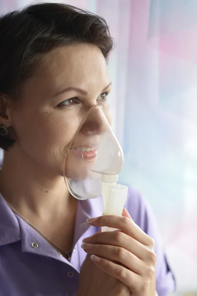 Young woman doing inhalation - Stock Image - Everypixel