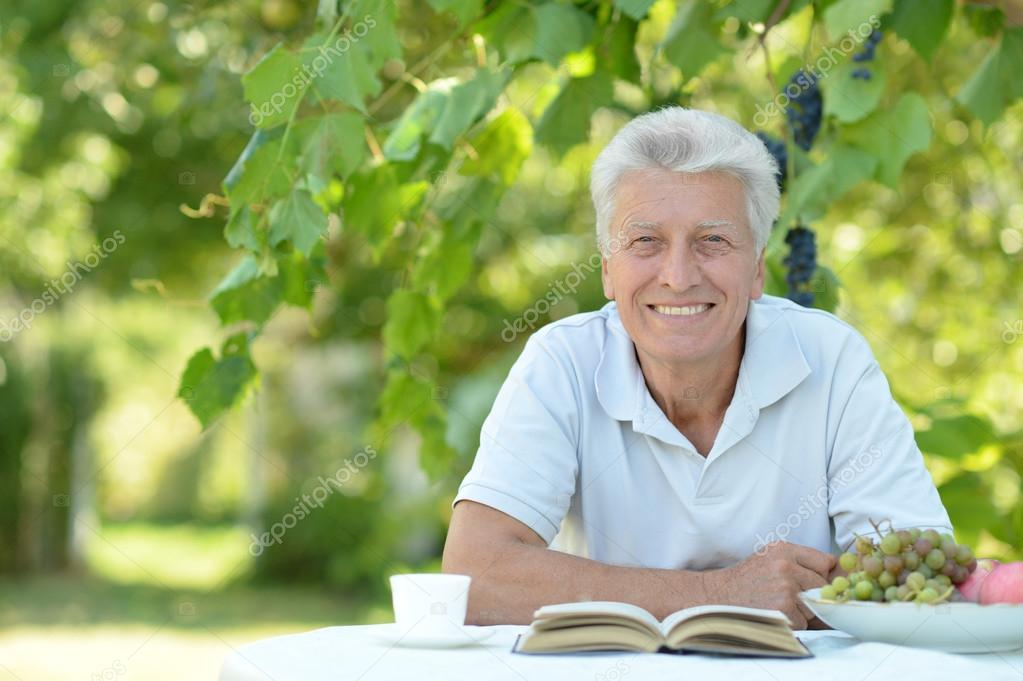 Older man with book — Stock Photo © aletia #78188484