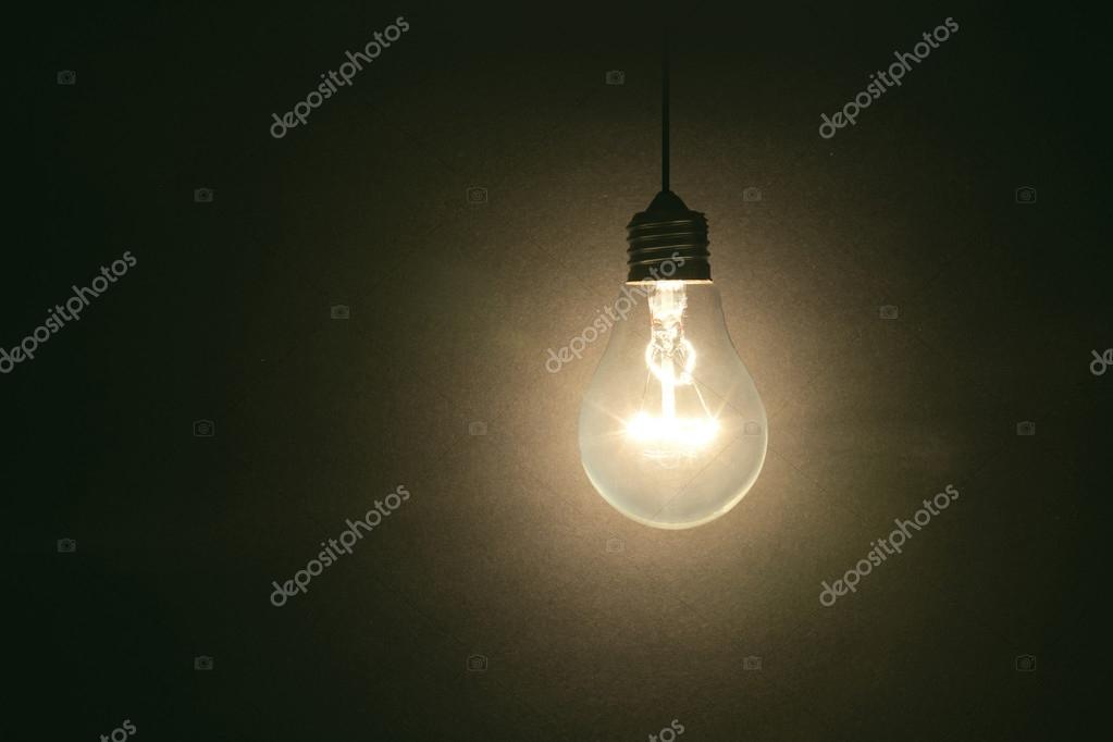 Light bulb on dark background Stock Photo by ©Devon 106616990