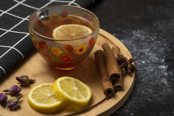 Herbal winter tea in the cups with spices on a wooden board. High ...