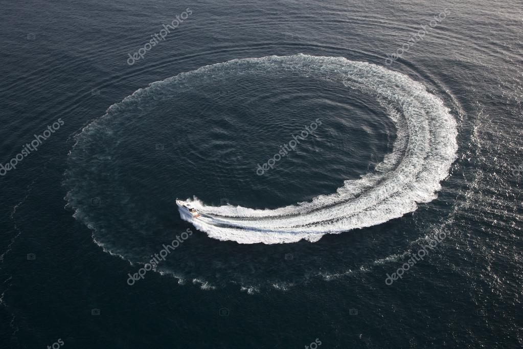 Small yacht making a circle in the water Stock Photo by ©ImageSupply ...