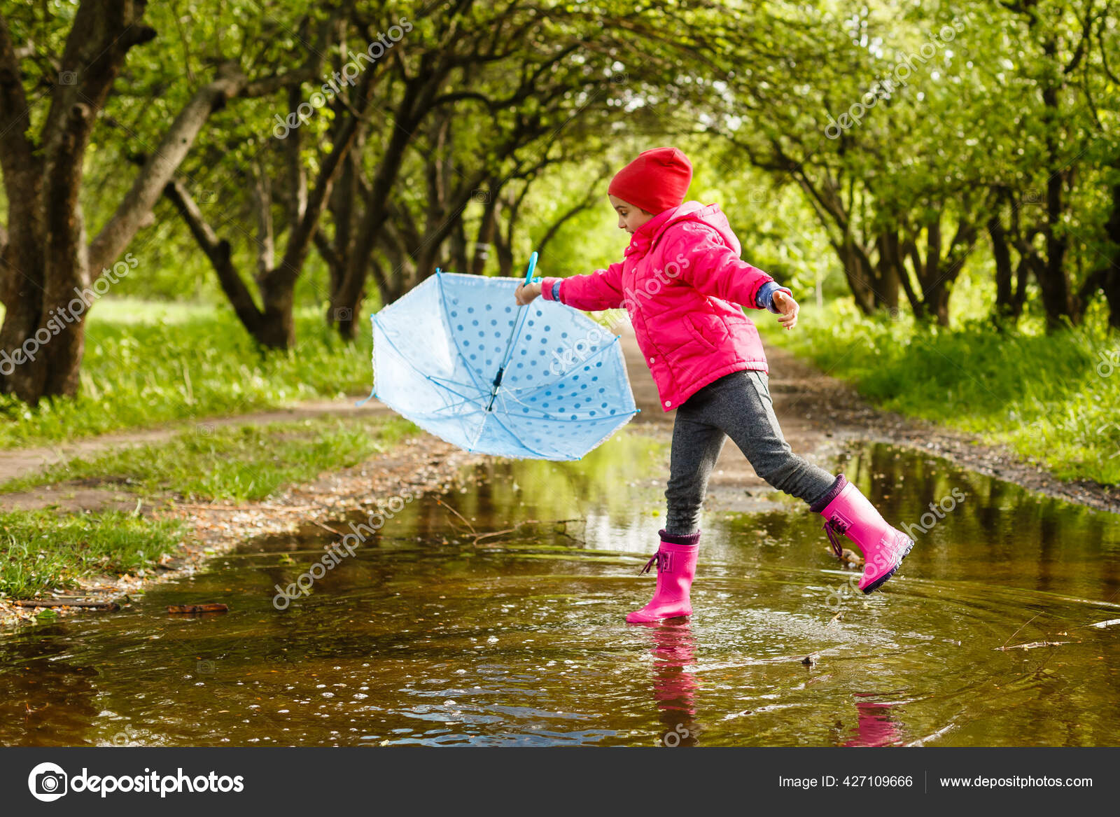 Little Girl Riding Bike Water Puddle Stock Photo by ©sinenkiy 427109666
