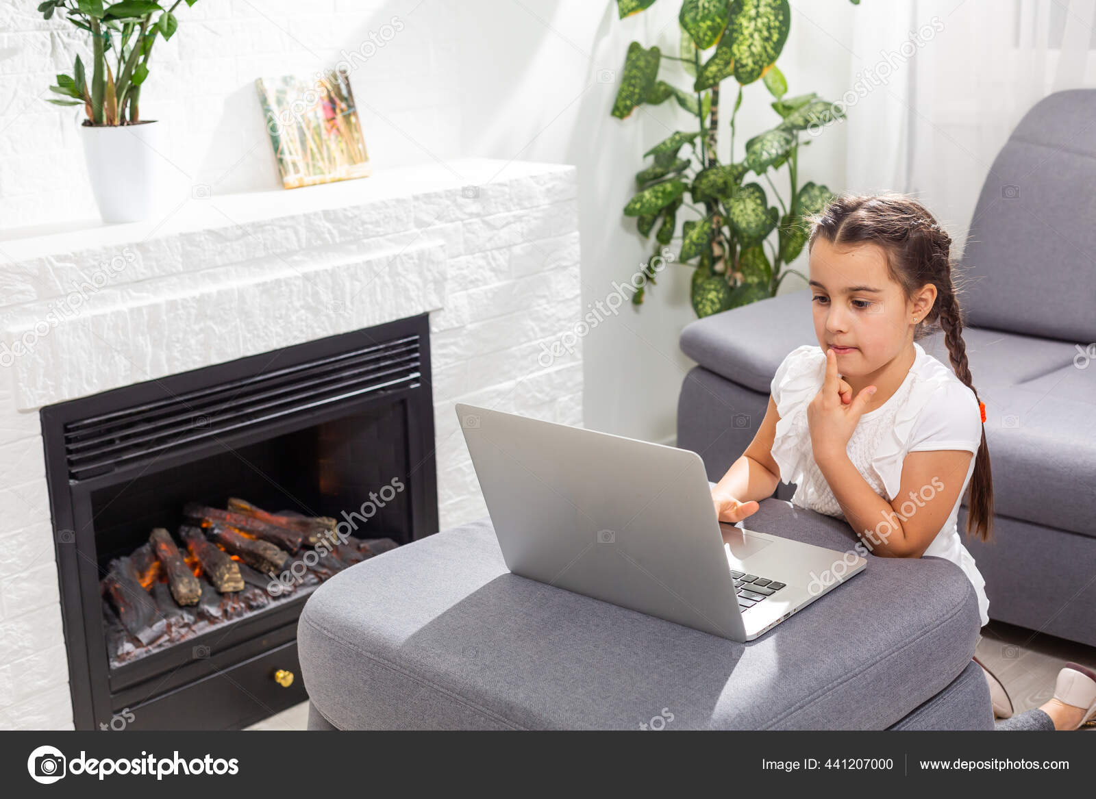 Kids distance learning. Cute little girl using laptop at home ...