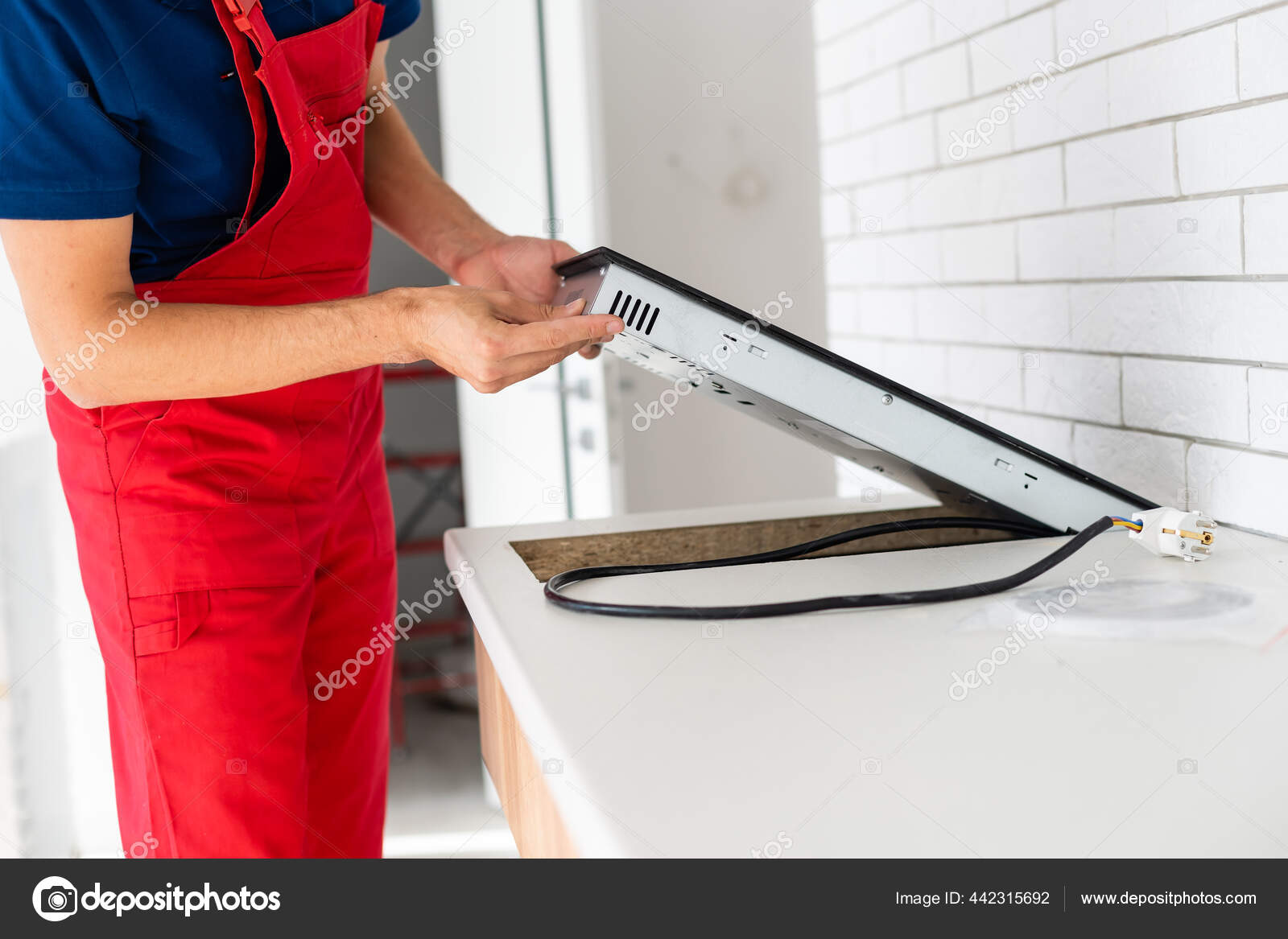 Installation of induction stove or cooktop by a master. Stock Photo by ...