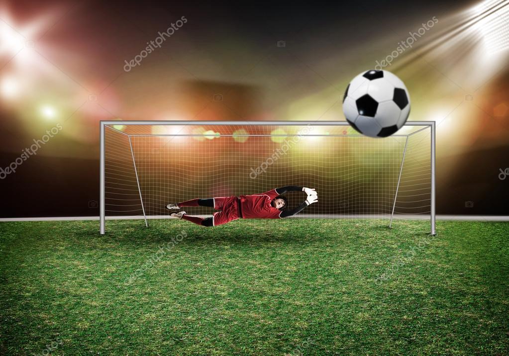 Goalkeeper jumping to catching ball Stock Photo by ©Khakimullin 101257300