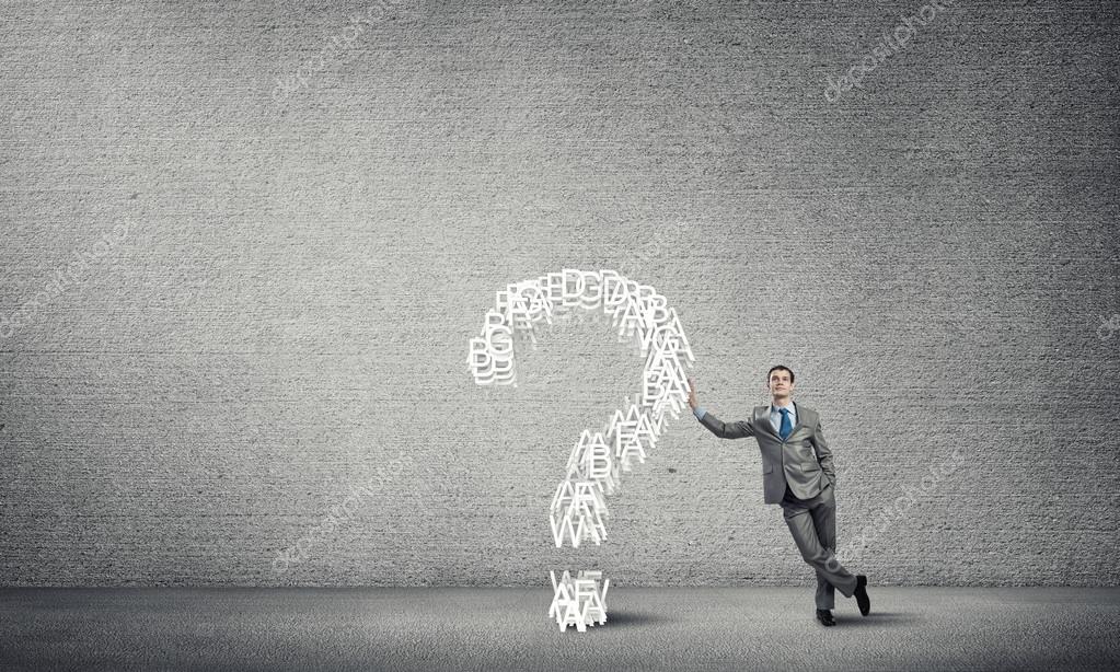 Businessman leaning on big question mark — Stock Photo © Khakimullin ...