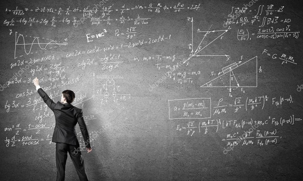 Teacher writing formulas on blackboard — Stock Photo © Khakimullin ...