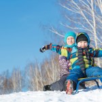Two kids sliding with sledding in the snow Stock Photo by ©pio3 14976577