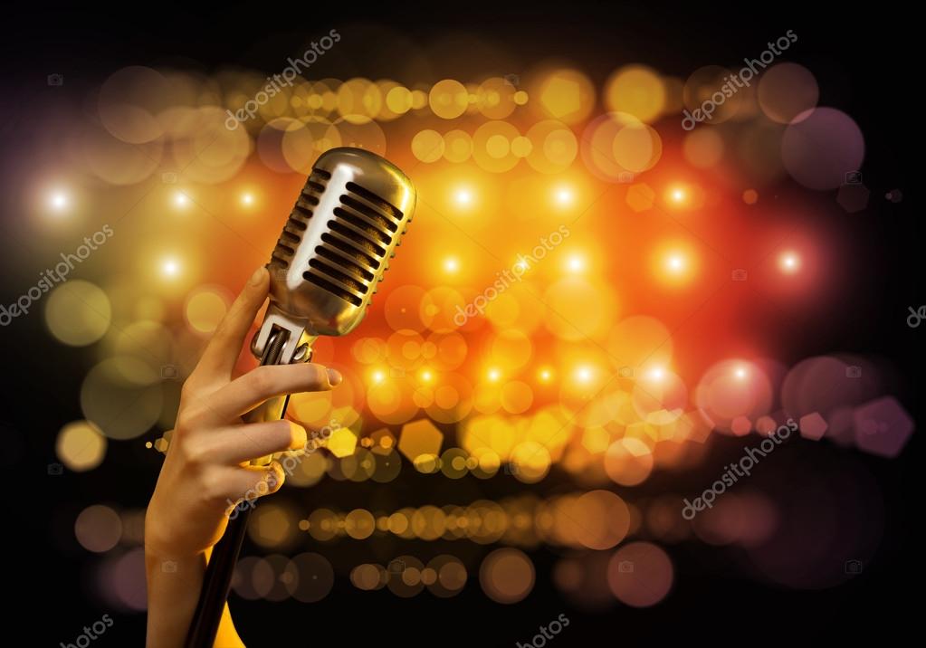 Singer holding microphone Stock Photo by ©Khakimullin 61565689