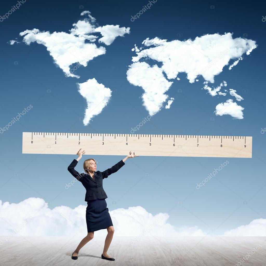 Businesswoman measuring world map Stock Photo by ©Khakimullin 86529568
