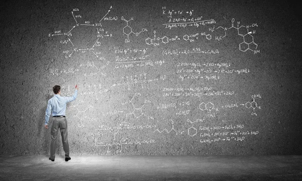 Man drawing formulas Stock Photo by ©Khakimullin 94778988