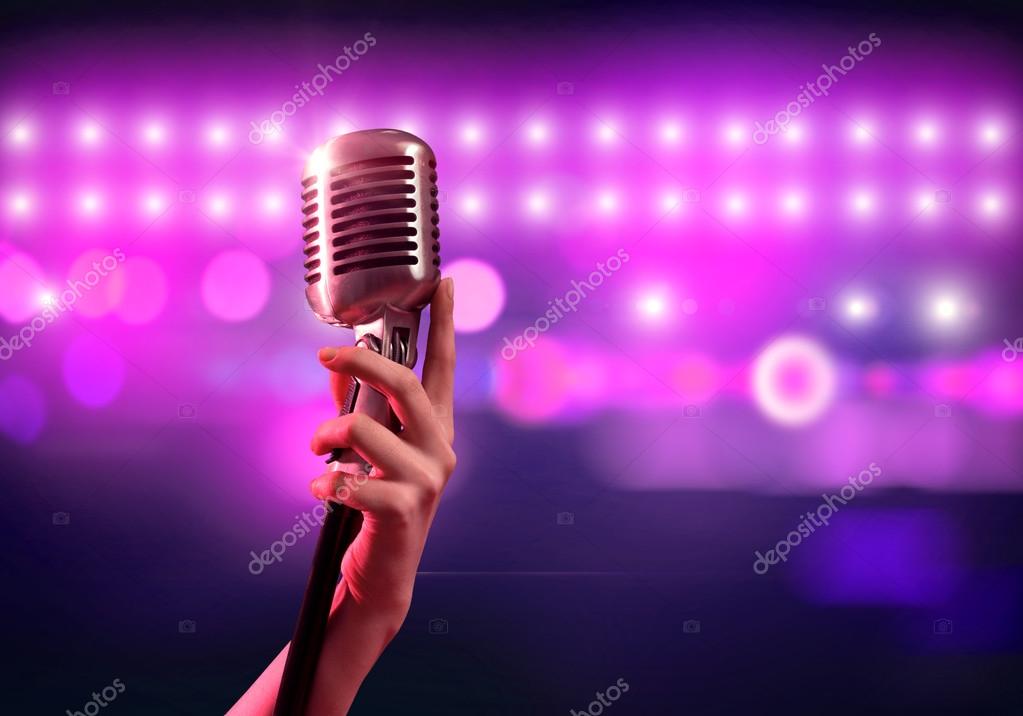 Female hand holding microphone — Stock Photo © Khakimullin #93100496