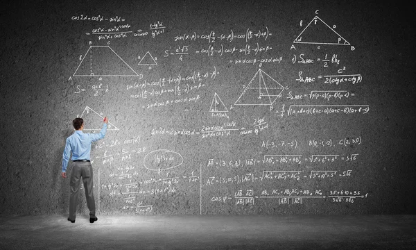 Man drawing formulas Stock Photo by ©Khakimullin 94778988