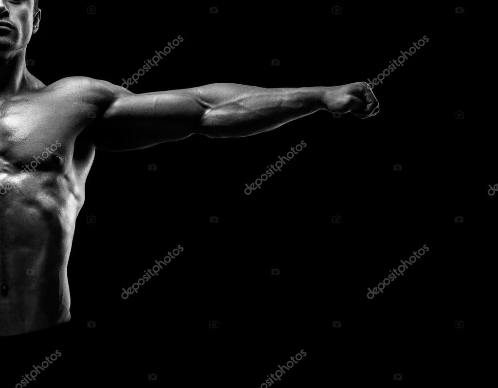 Handsome muscular bodybuilder posing and keeping arms outstretch Stock ...