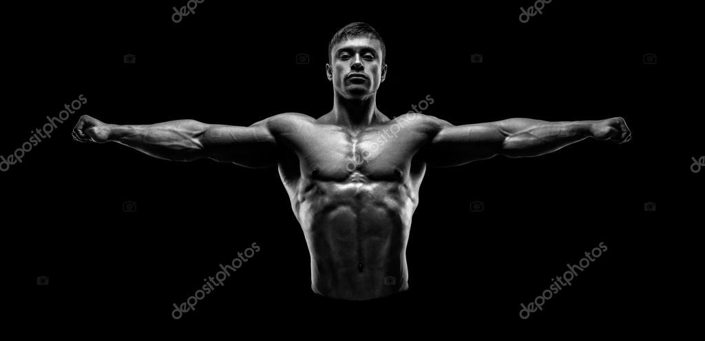 Handsome muscular bodybuilder posing and keeping arms outstretch Stock ...