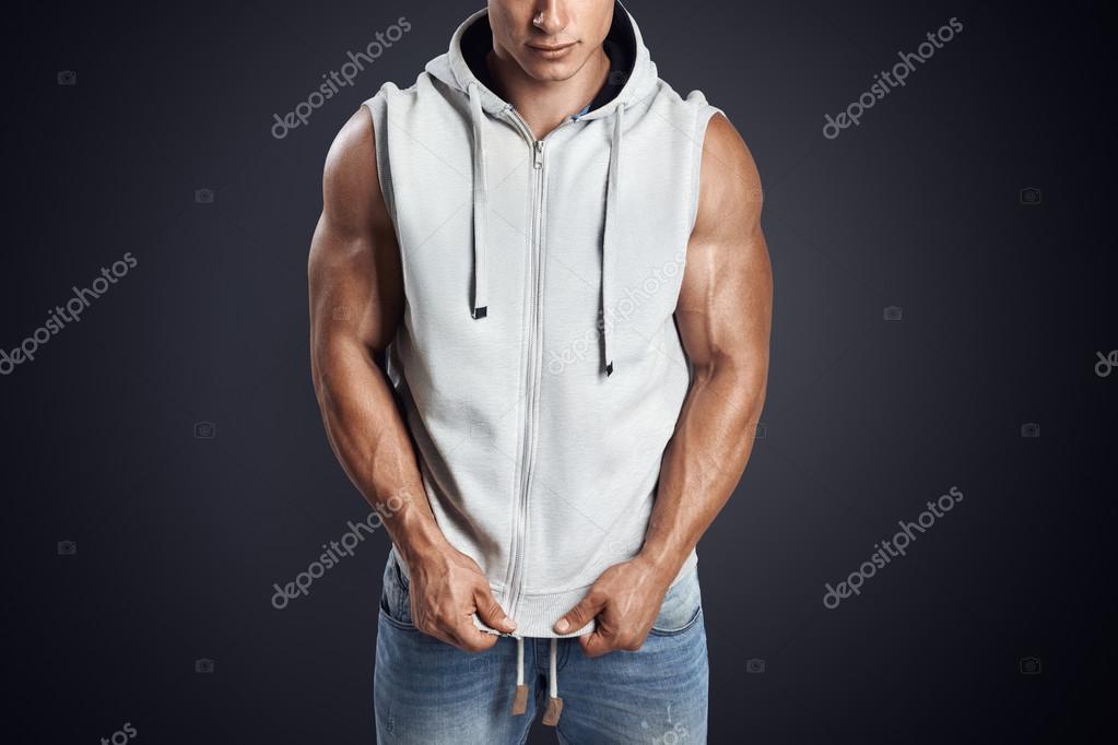 Handsome bodybuilder wearing gray sleeveless hoodie Stock Photo by ...
