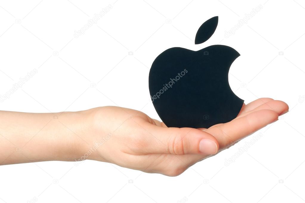 Hand holds apple logotype printed on paper on white background — Stock ...