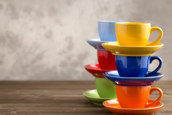 Stack of six multicolored cups on table from left side Stock Photo by ...