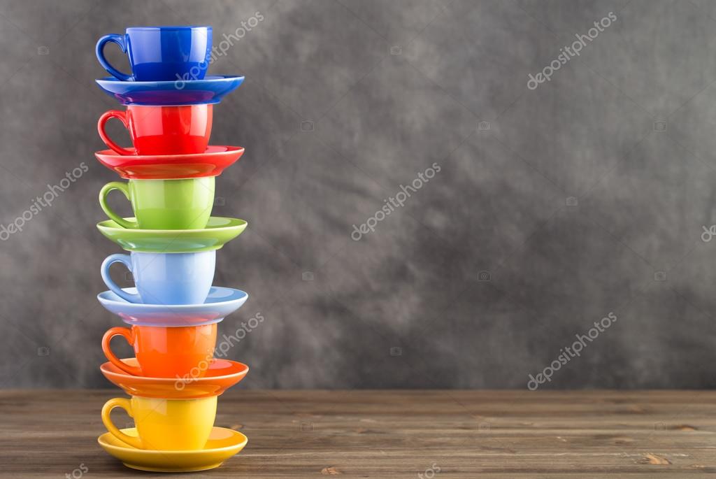 Stack of six multicolored cups on table from left side Stock Photo by ...