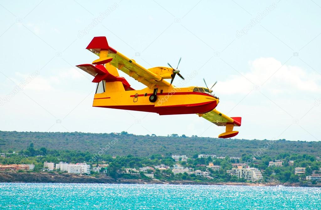 Aerial firefighting. Aircraft preparing to collect sea water. Stock ...